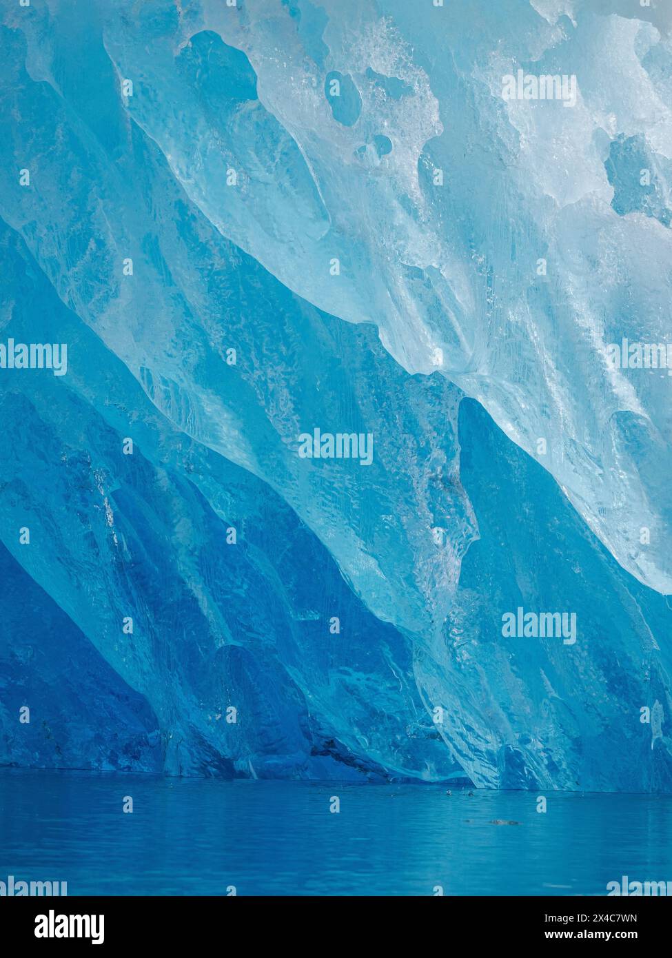 Iceberg in the fjord with melt structure. Landscape in the Johan ...