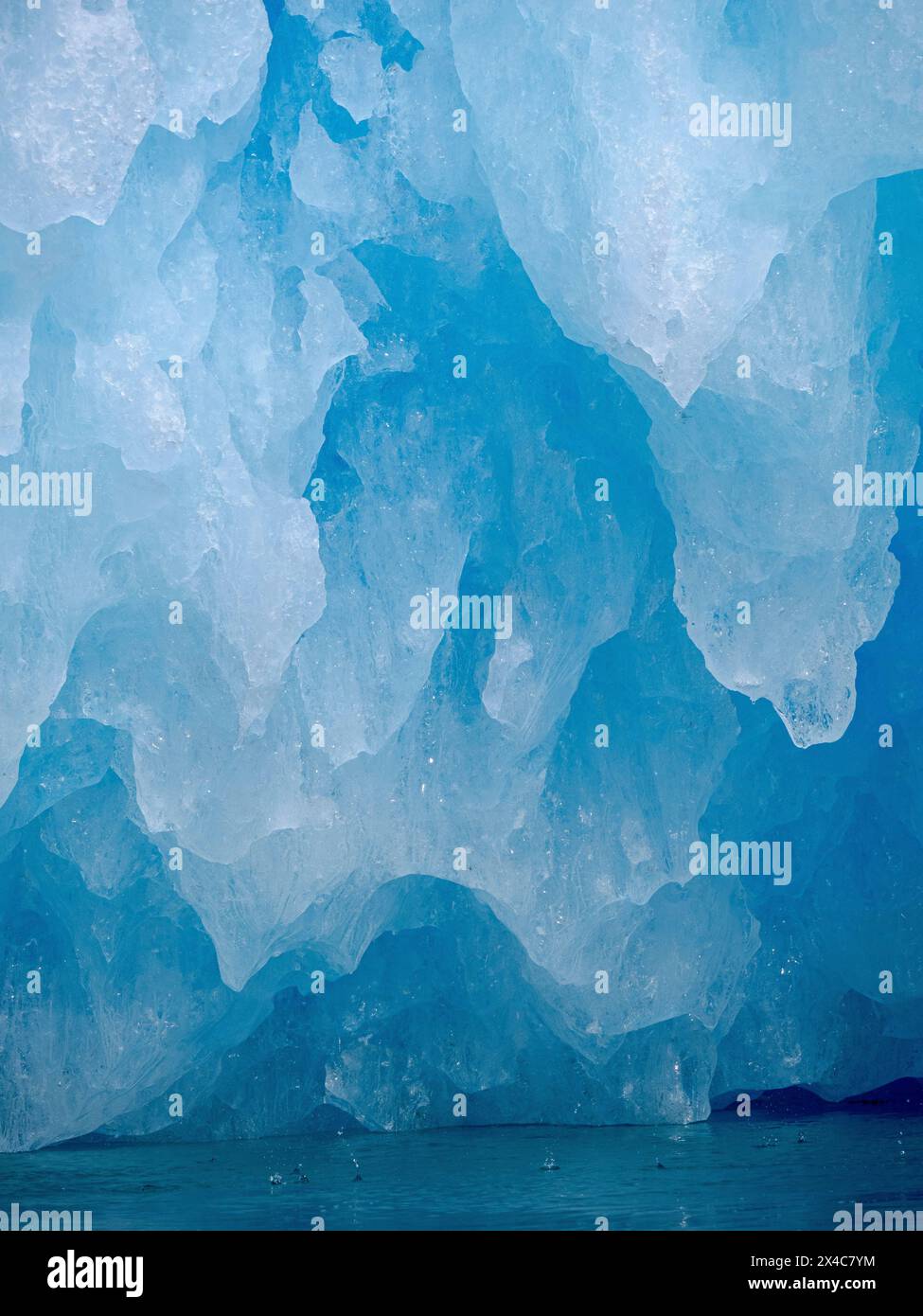 Iceberg in the fjord with melt structure. Landscape in the Johan ...