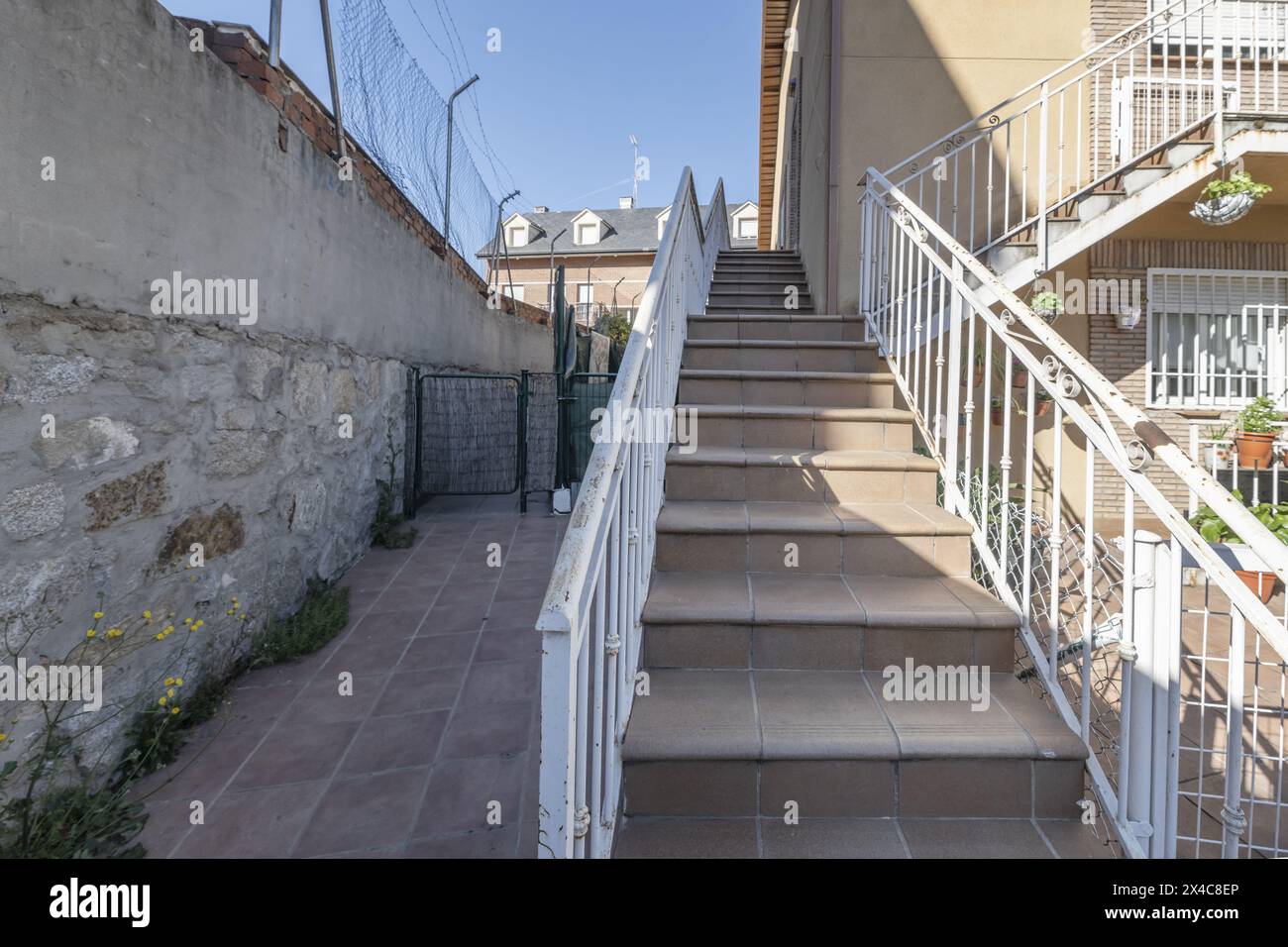 Terracotta metal stairs with white railings in a residential apartment ...