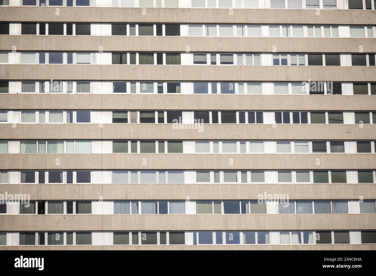 facade with granite cladding and a multitude of similar windows, some ...