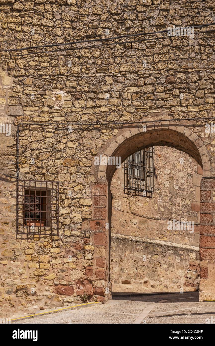 Access arch in an old yellow stone wall Stock Photo - Alamy