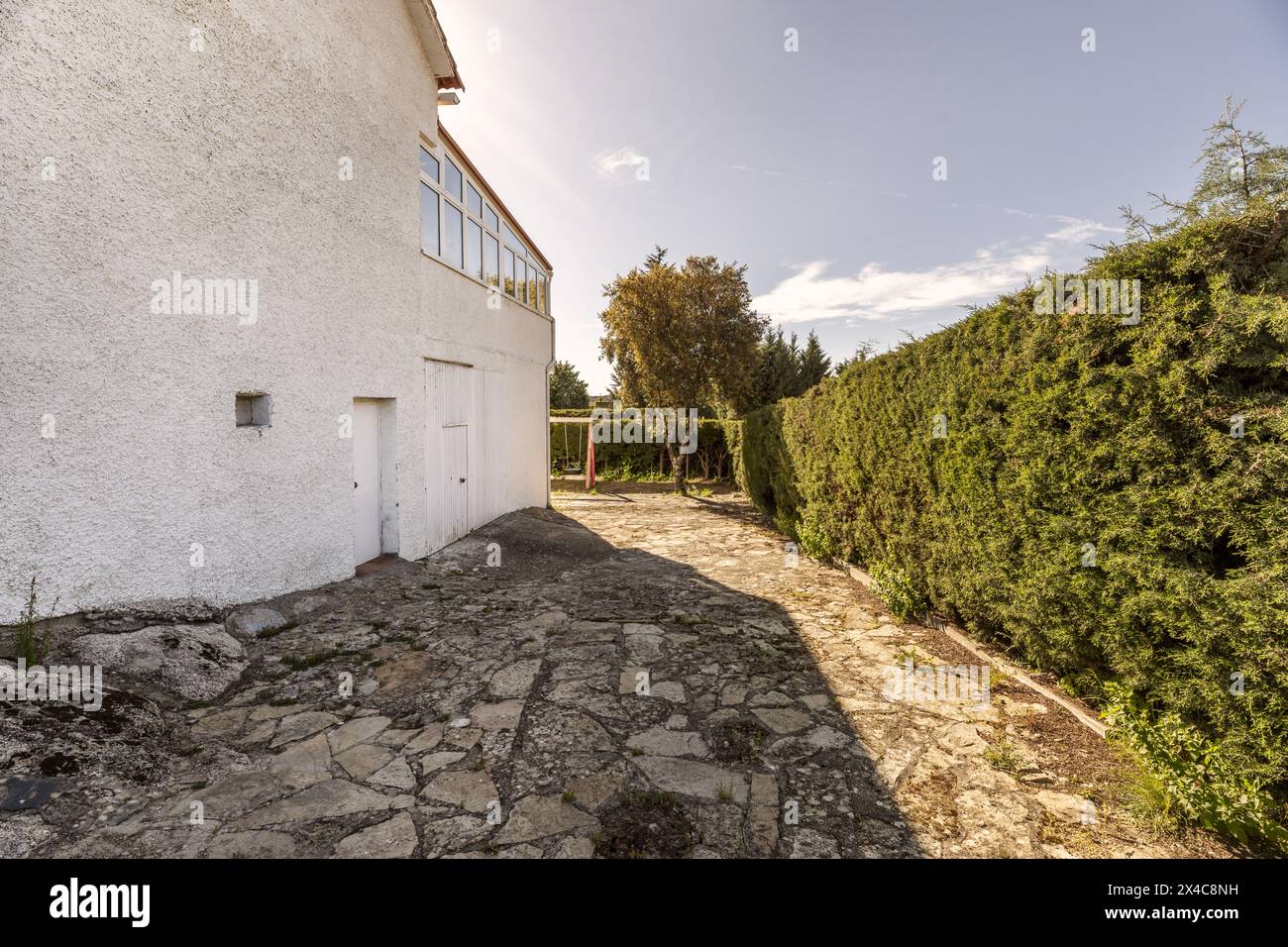 A stone path on the side of a single-family residential home with a ...