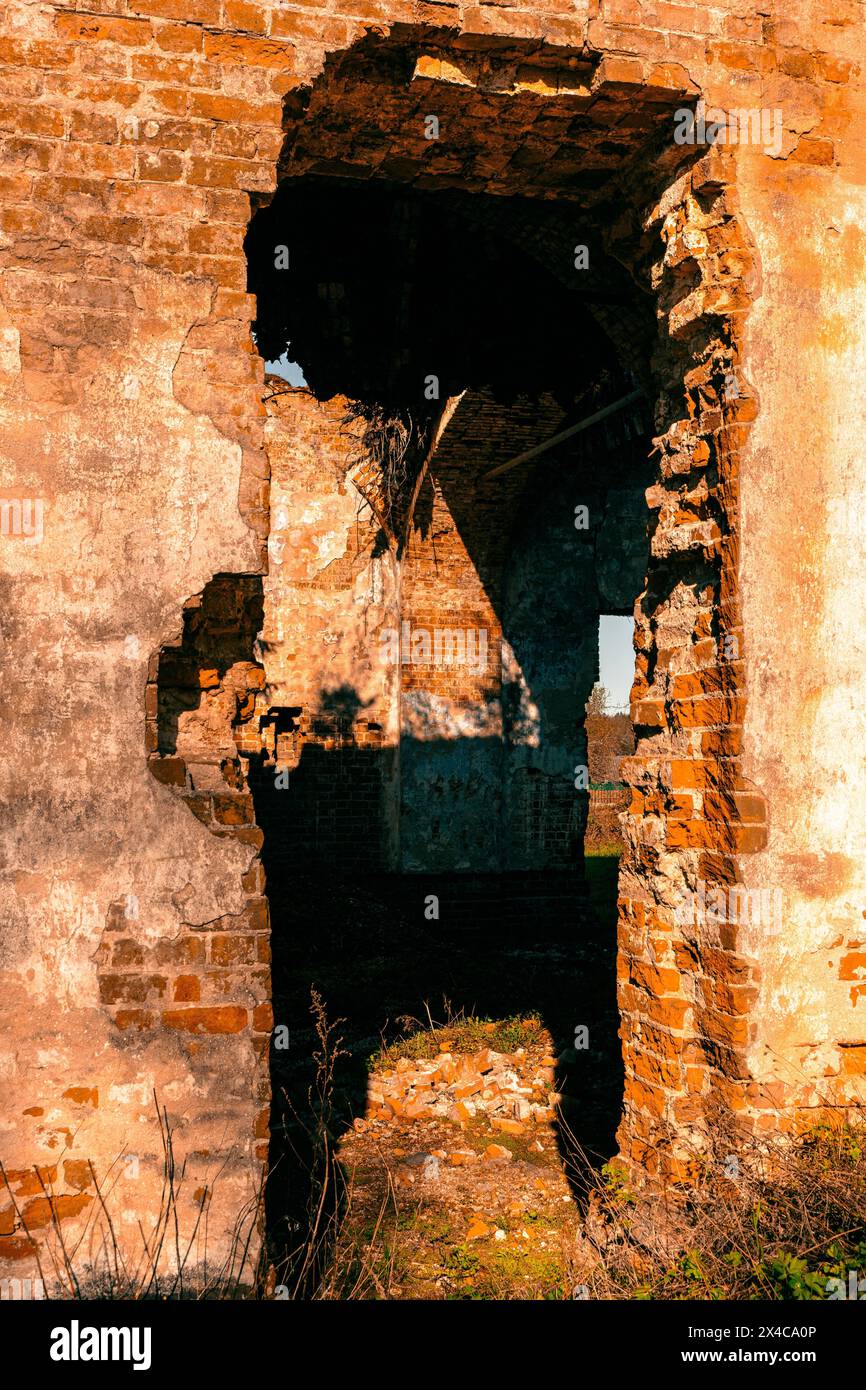 Arched entrance to a ruined brick building. Selected focus. Vertical ...