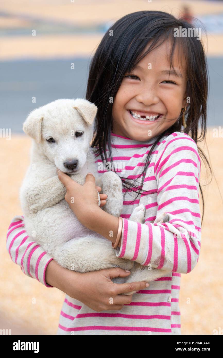 Young girl playing with a dog, Lao Cai Province, Vietnam Stock Photo ...