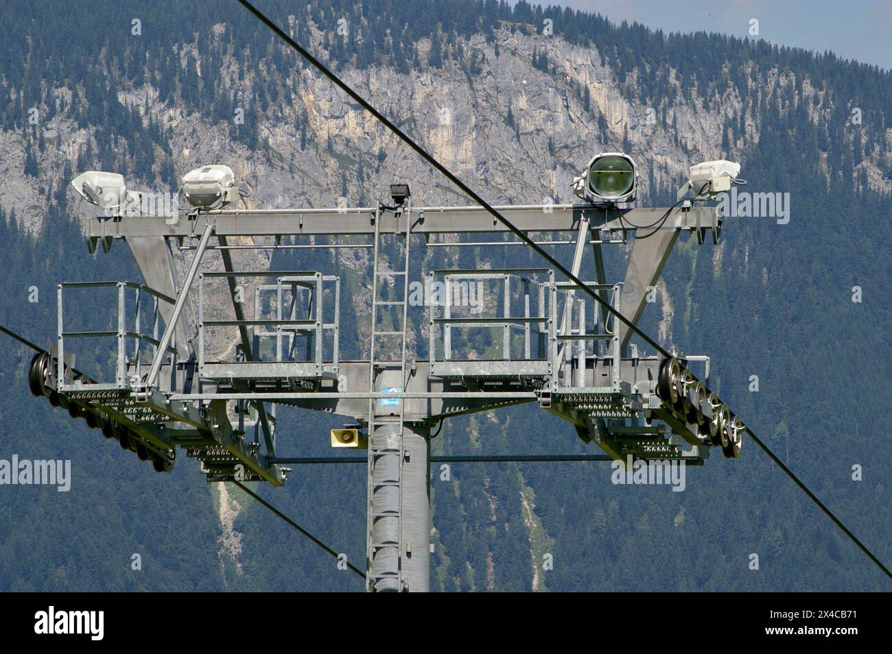 Cable car support system detail with mountains behind Stock Photo - Alamy