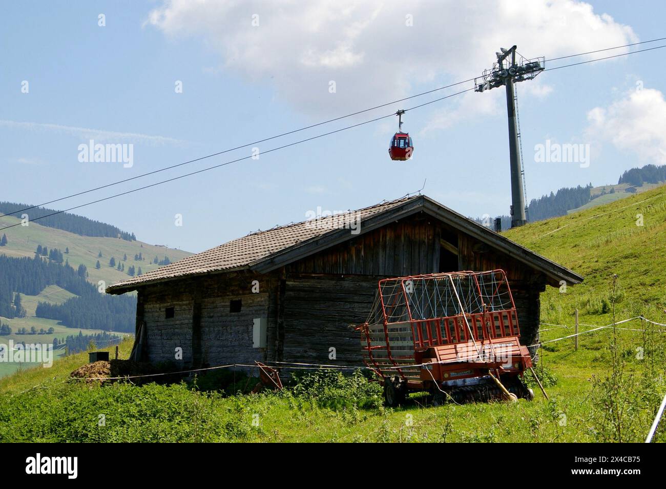 Rustic wooden shed and carriage under a cable car gondola Stock Photo ...