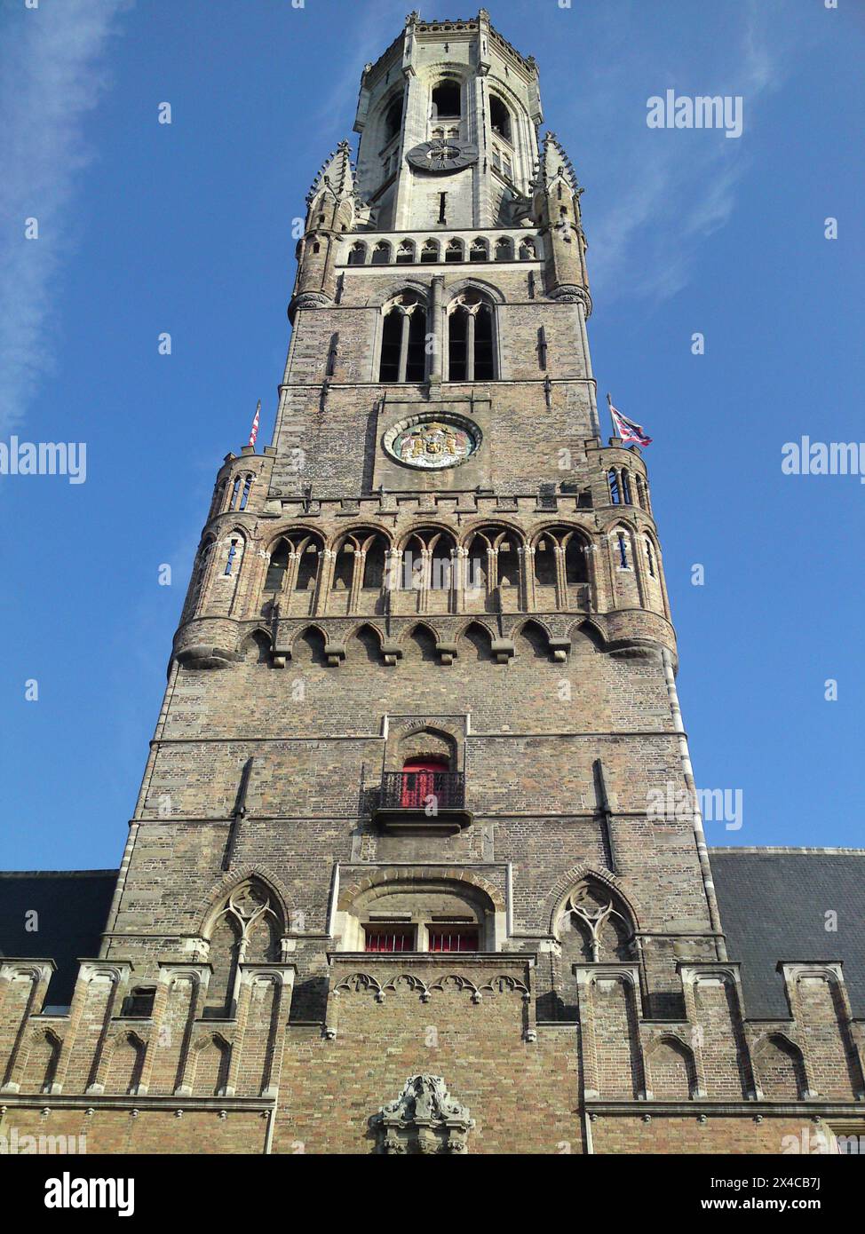 The Belfry of Bruges tower under a blue sky. Medieval bell tower on the ...