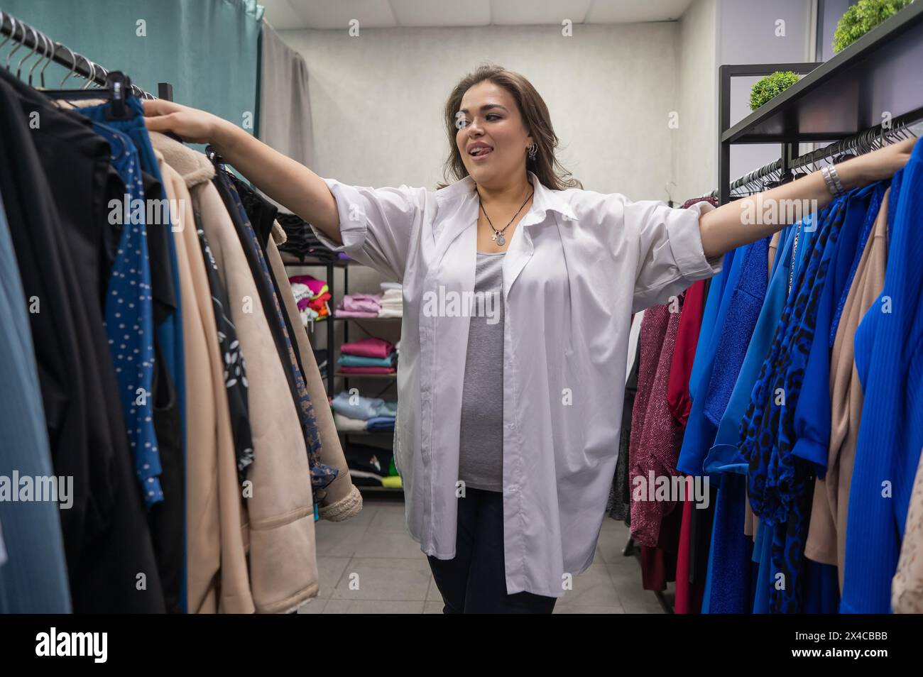 A fat woman chooses clothes in a plus size store Stock Photo - Alamy