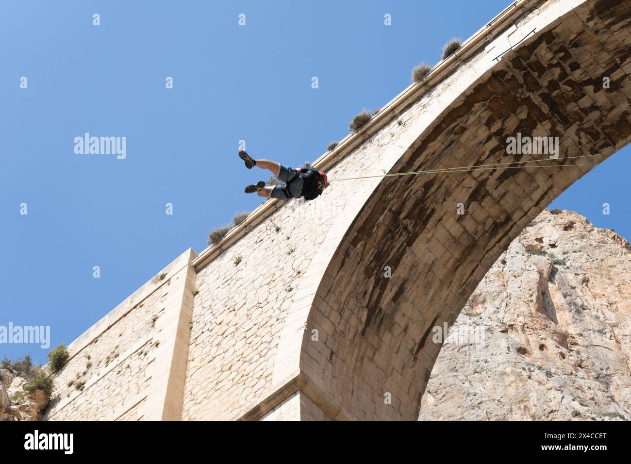 Bottom view of an unrecognizable person bungee jumping from a historic ...