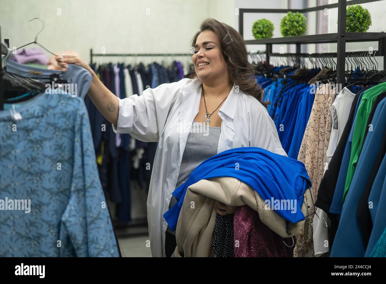 A fat woman chooses clothes in a plus size store Stock Photo - Alamy