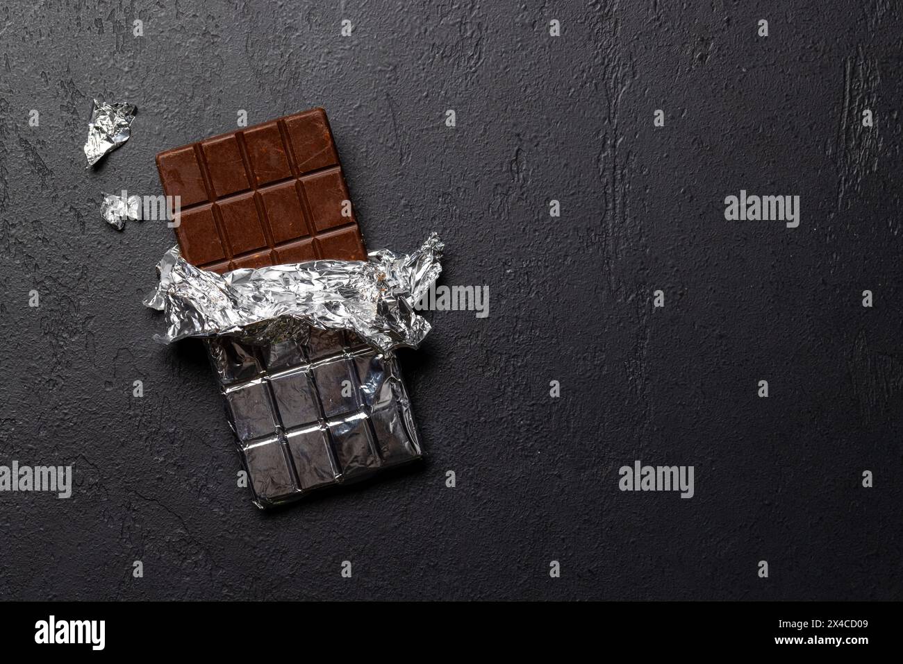 Sweet temptation: Chocolate bar on stone background with copy space ...