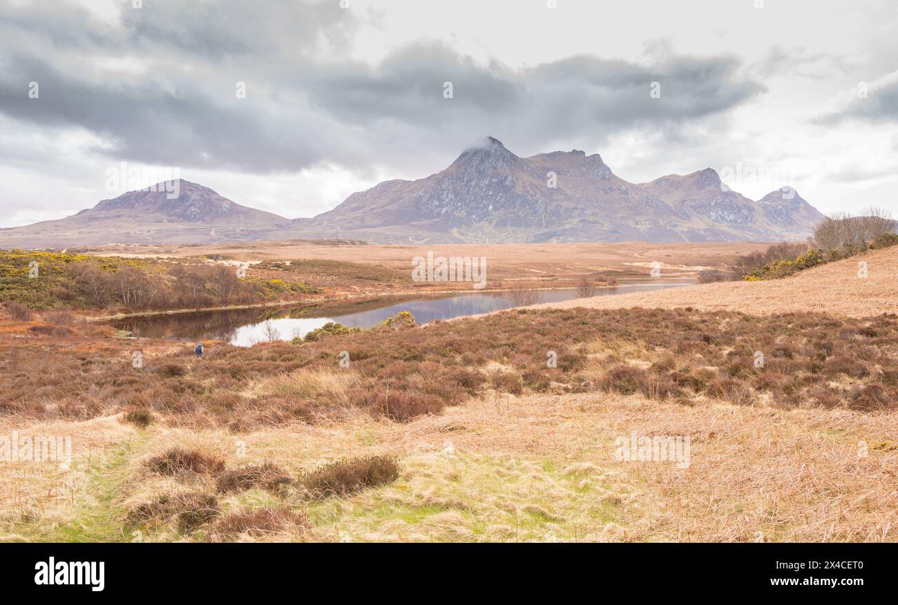 The mountain range of Ben Loyal reflected in the still waters of Lochan ...