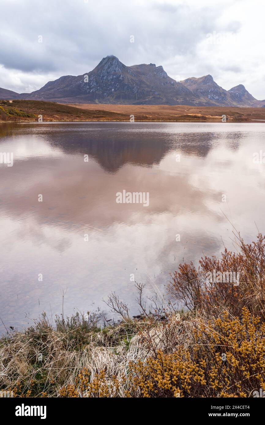 The mountain range of Ben Loyal reflected in the still waters of Lochan ...