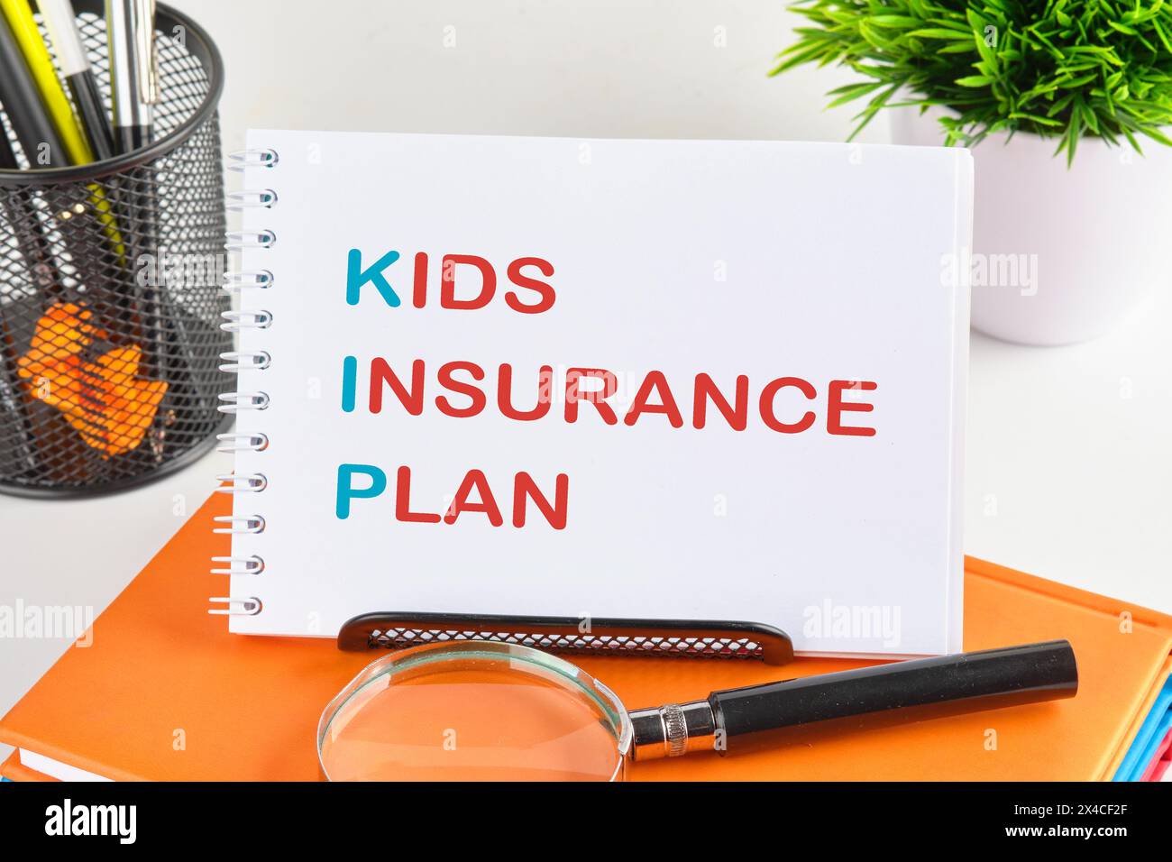 KIP kids insurance plan symbol on a blank sheet next to the magnifying ...