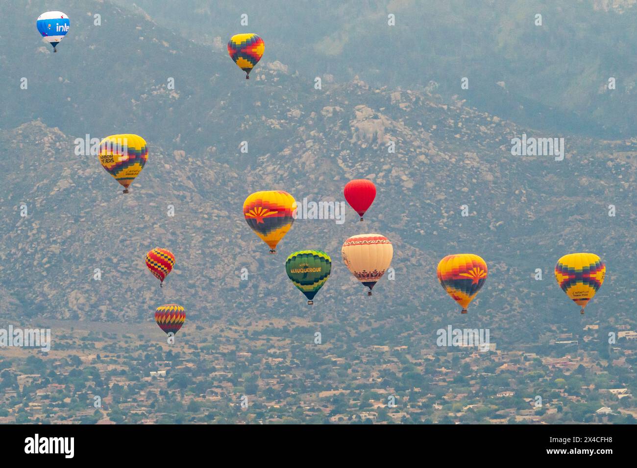 USA, New Mexico, Albuquerque. Hot air balloons flying over city at ...