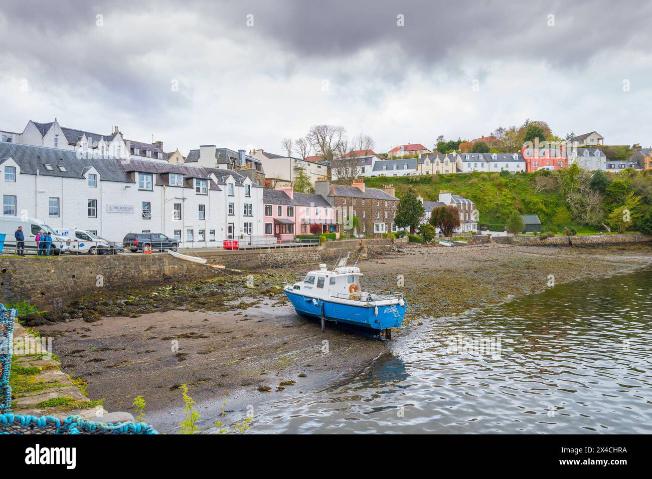 The pastel colourful painted buildings along the harbour wall in the ...