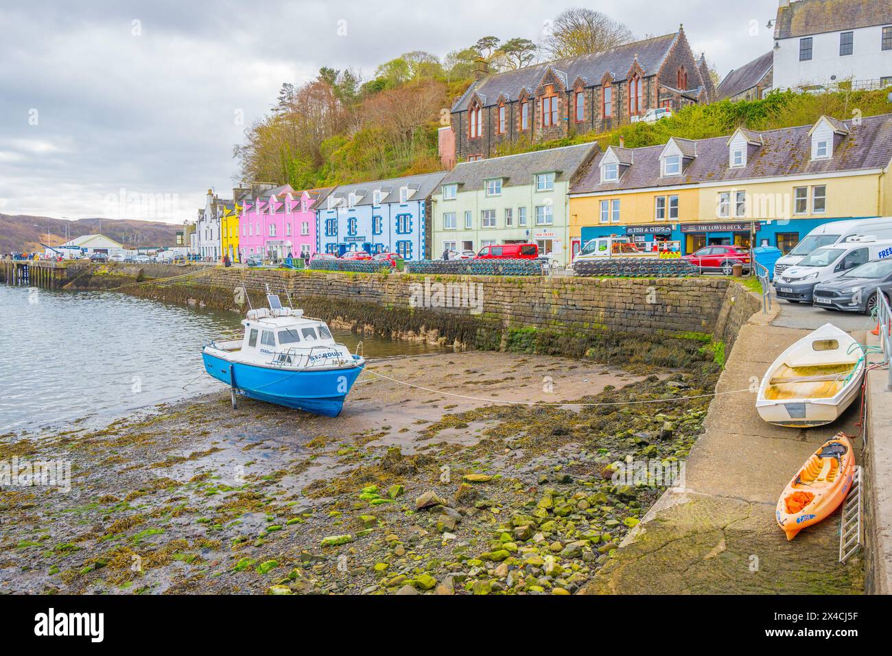 The pastel colourful painted buildings along the harbour wall in the ...