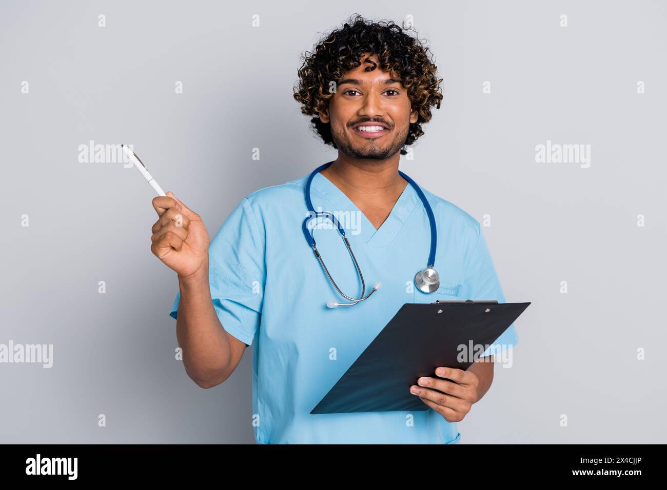 Photo of doc guy hold checklist demonstrate empty space isolated grey ...