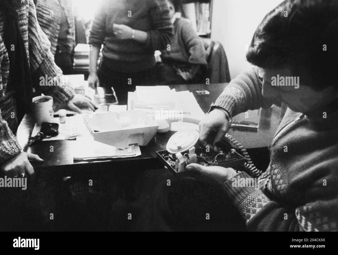 Bucharest, Romania, January 1990. Man removing a microphone from inside ...