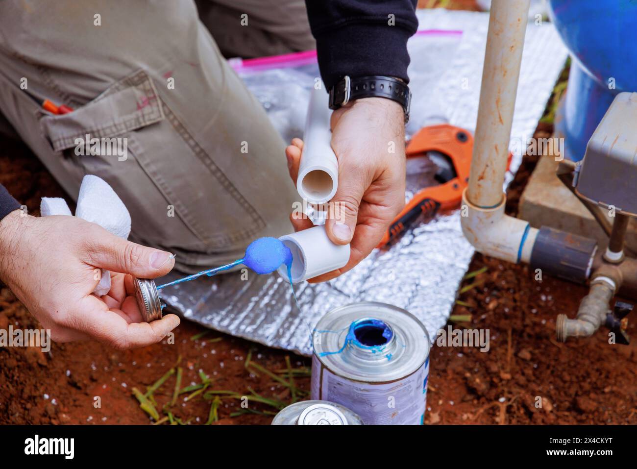 Glue is applied to pvc pipe before it is glued Stock Photo - Alamy