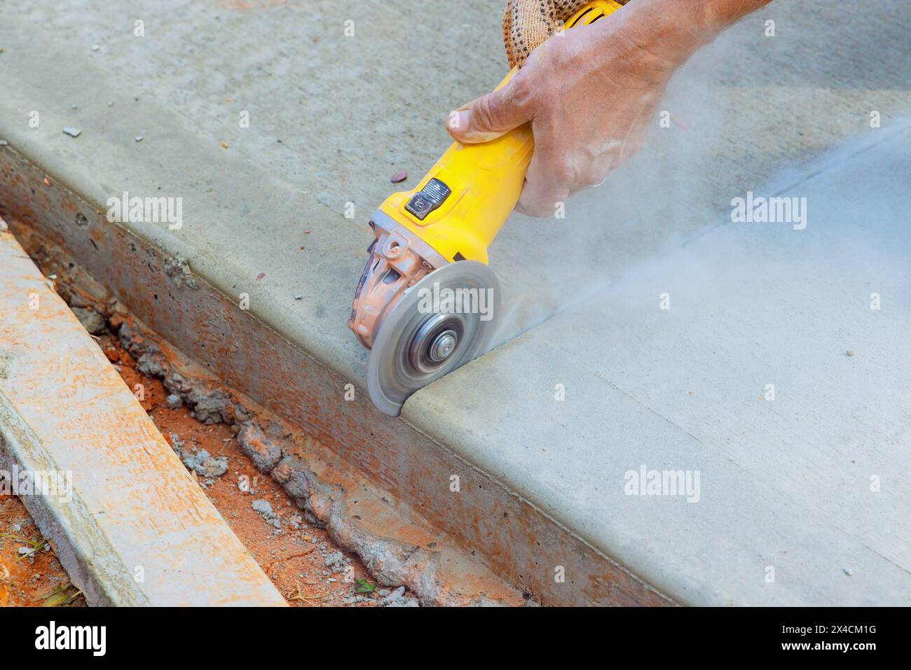 An employee of construction industry cuts concrete foundation after it ...