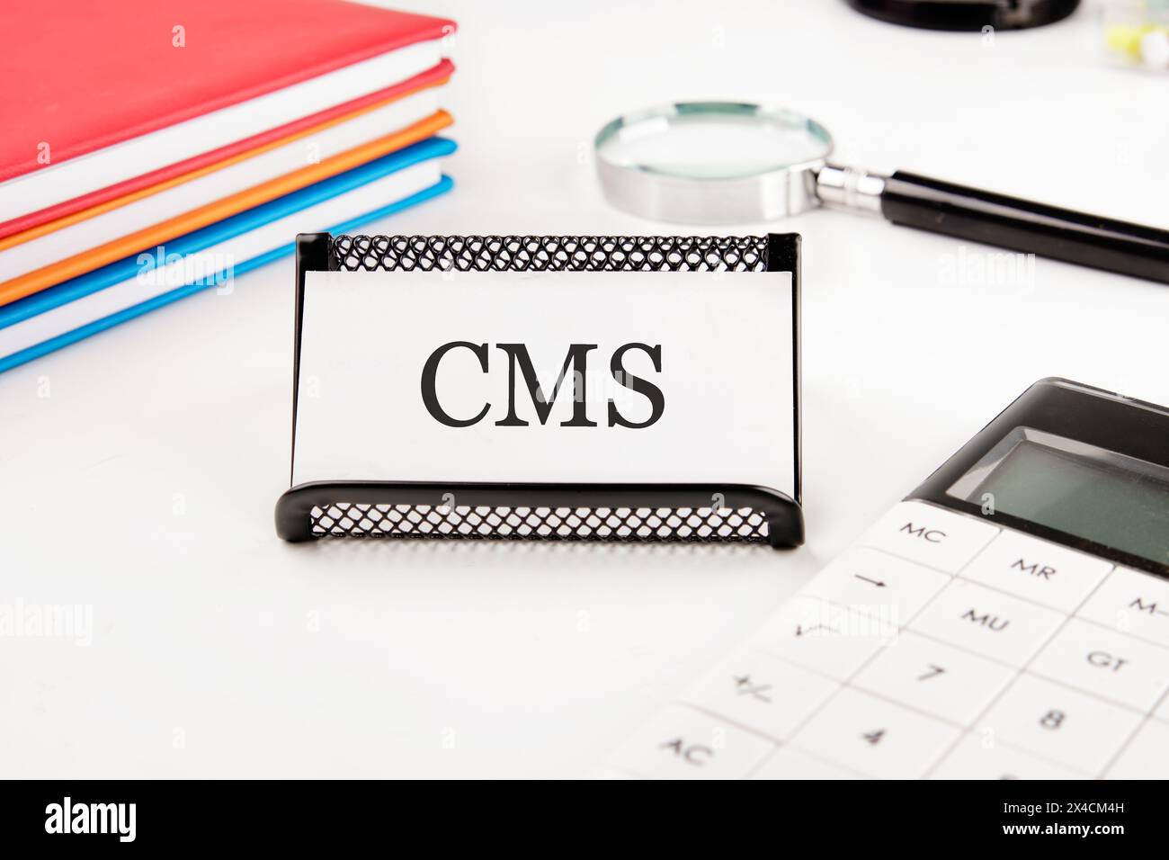 CMS (Custom Management System) written on a business card in a ...