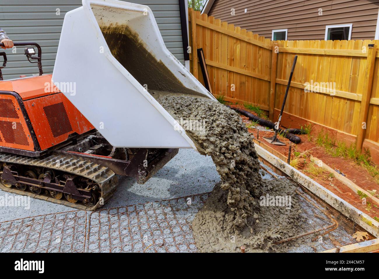 It is necessary to pour wet cement into framework from concrete buggy ...