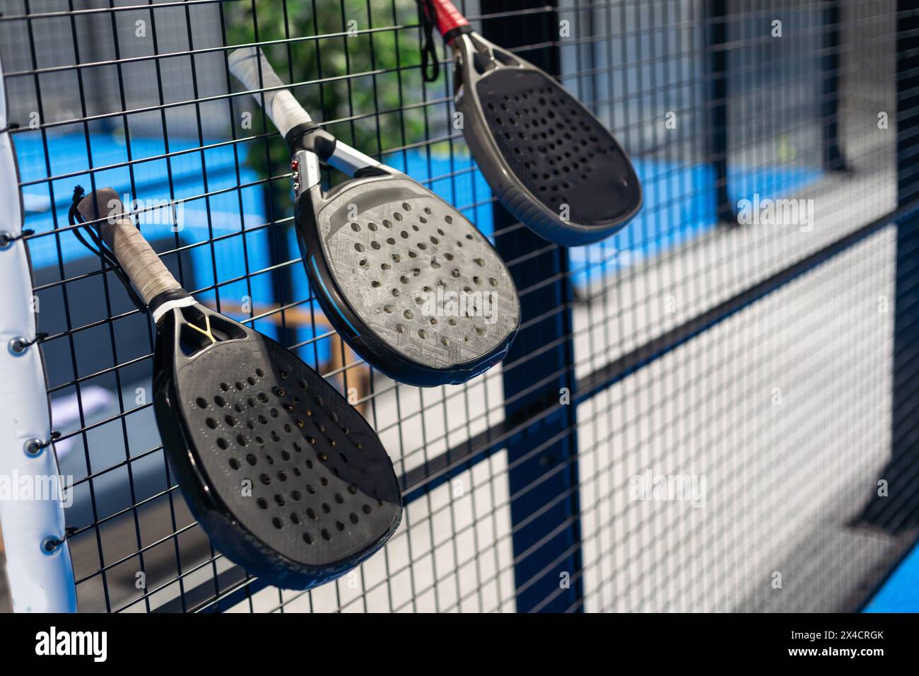 Paddle tennis: Padel racket and ball in front of an outdoor court Stock ...