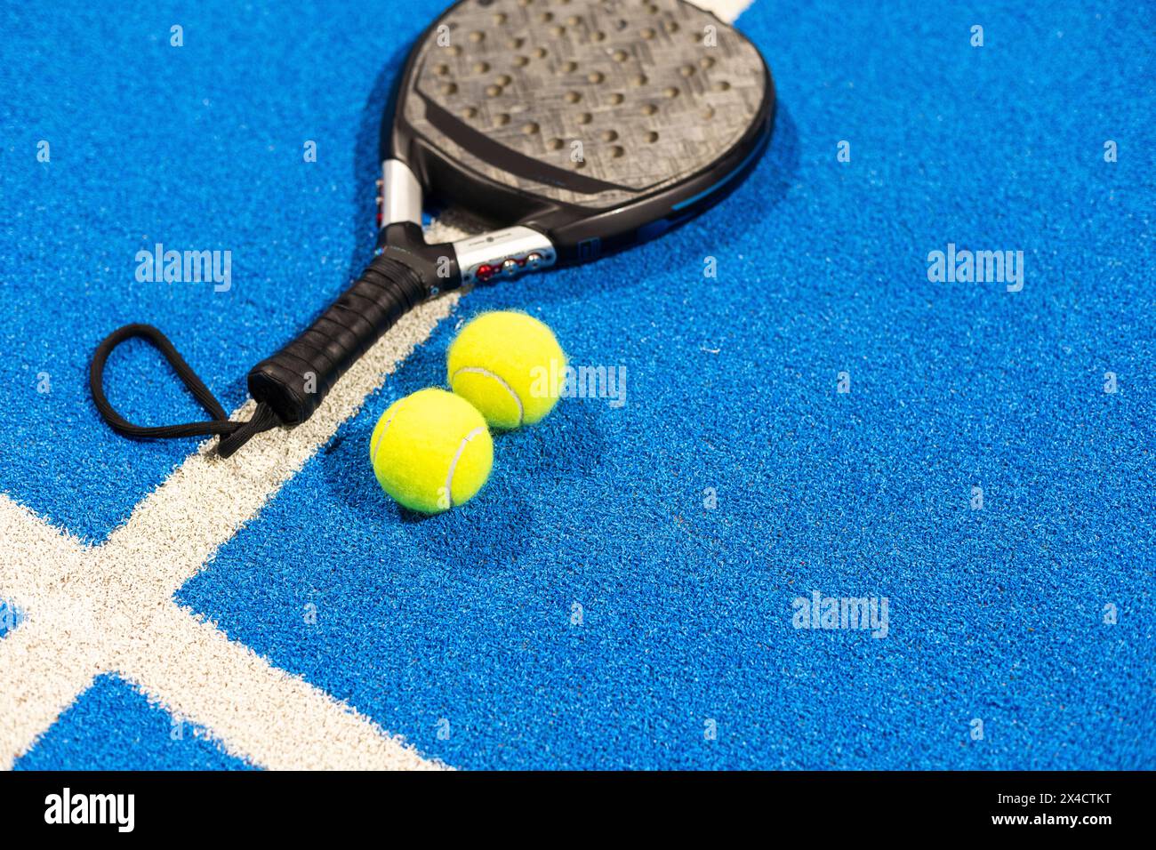 paddle tennis racket and balls on the blue paddle court Stock Photo - Alamy