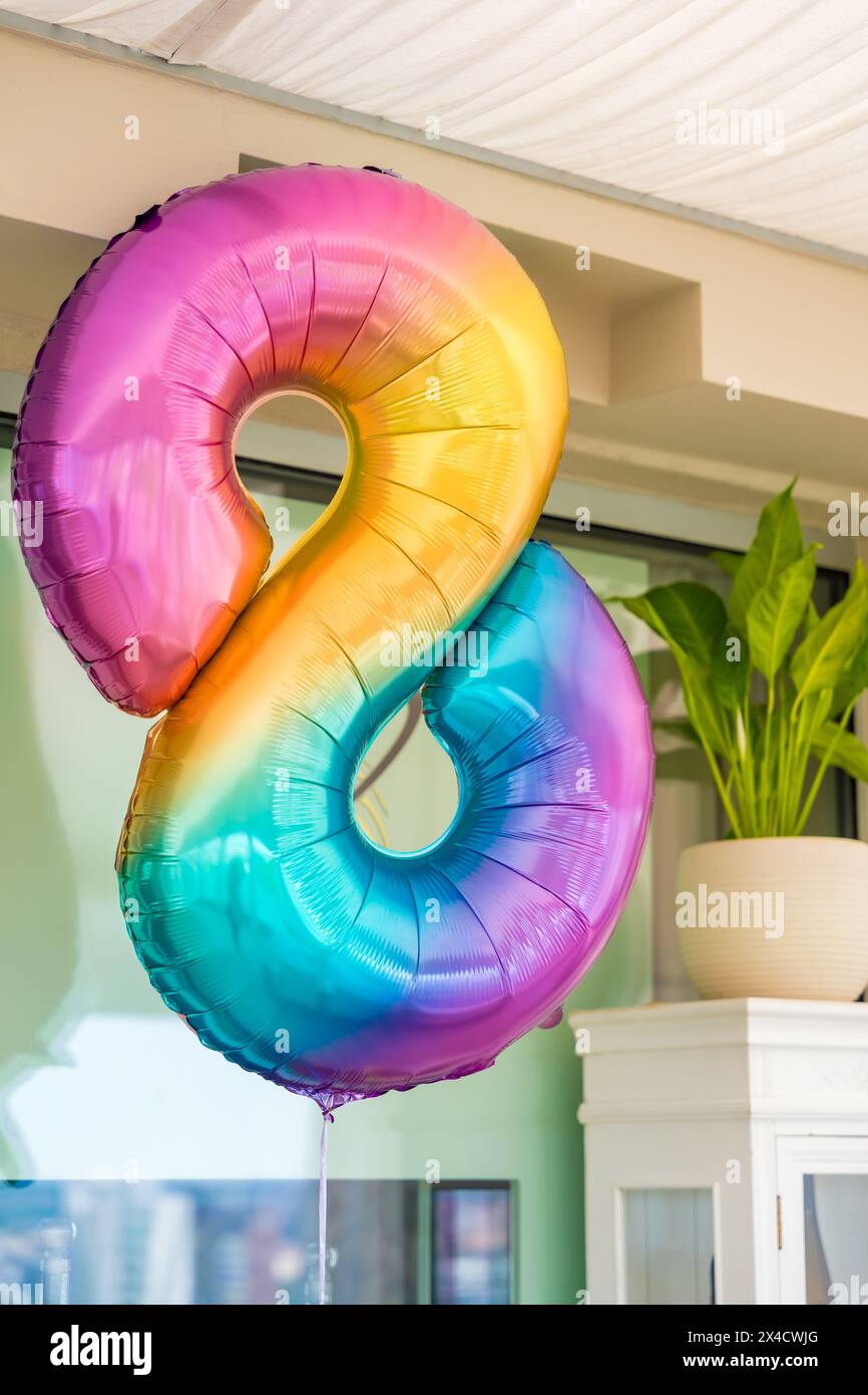 Rainbow helium balloon number eight. Birthday concept Stock Photo - Alamy