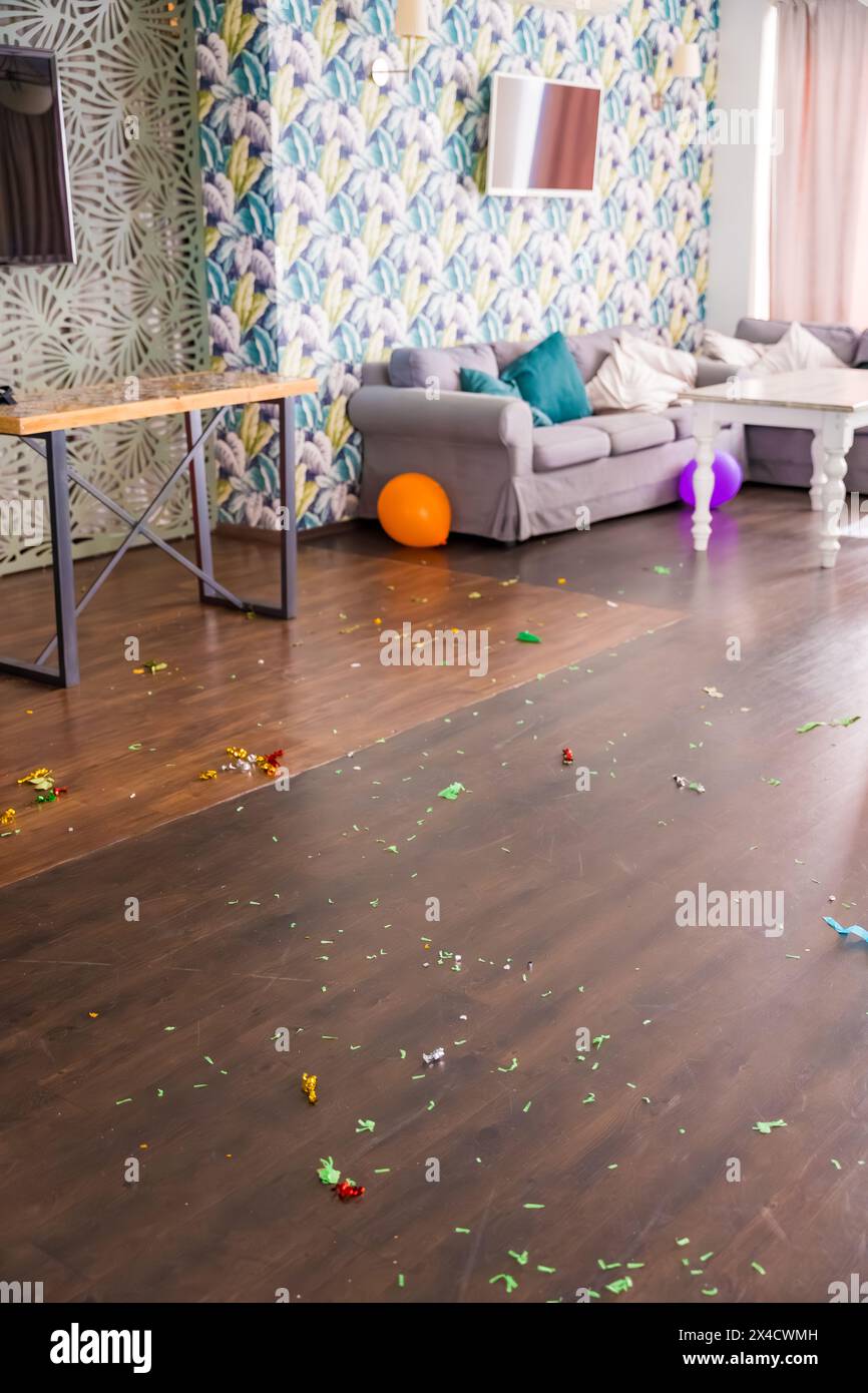 After the party. Empty room with furniture and TV with confetti and ...
