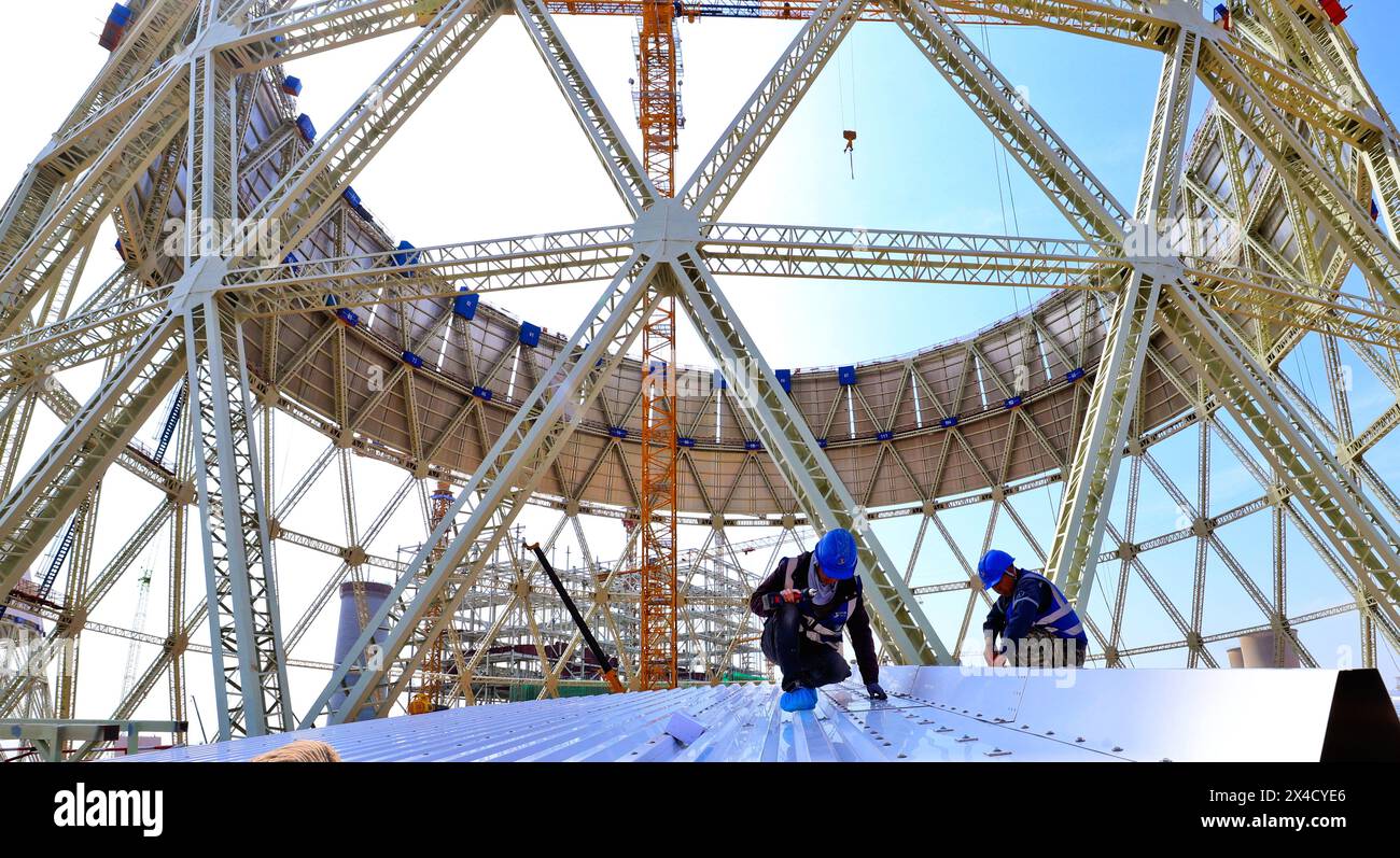 ZHANGYE, CHINA - MAY 2, 2024 - Builders weld and install steel ...