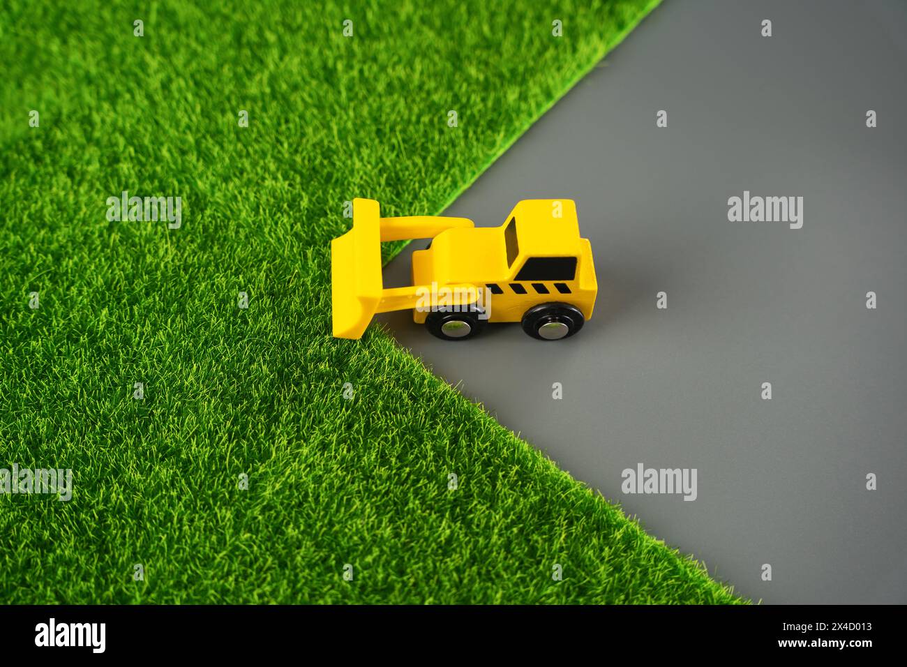 A bulldozer clears the natural landscape for construction. Expanding ...