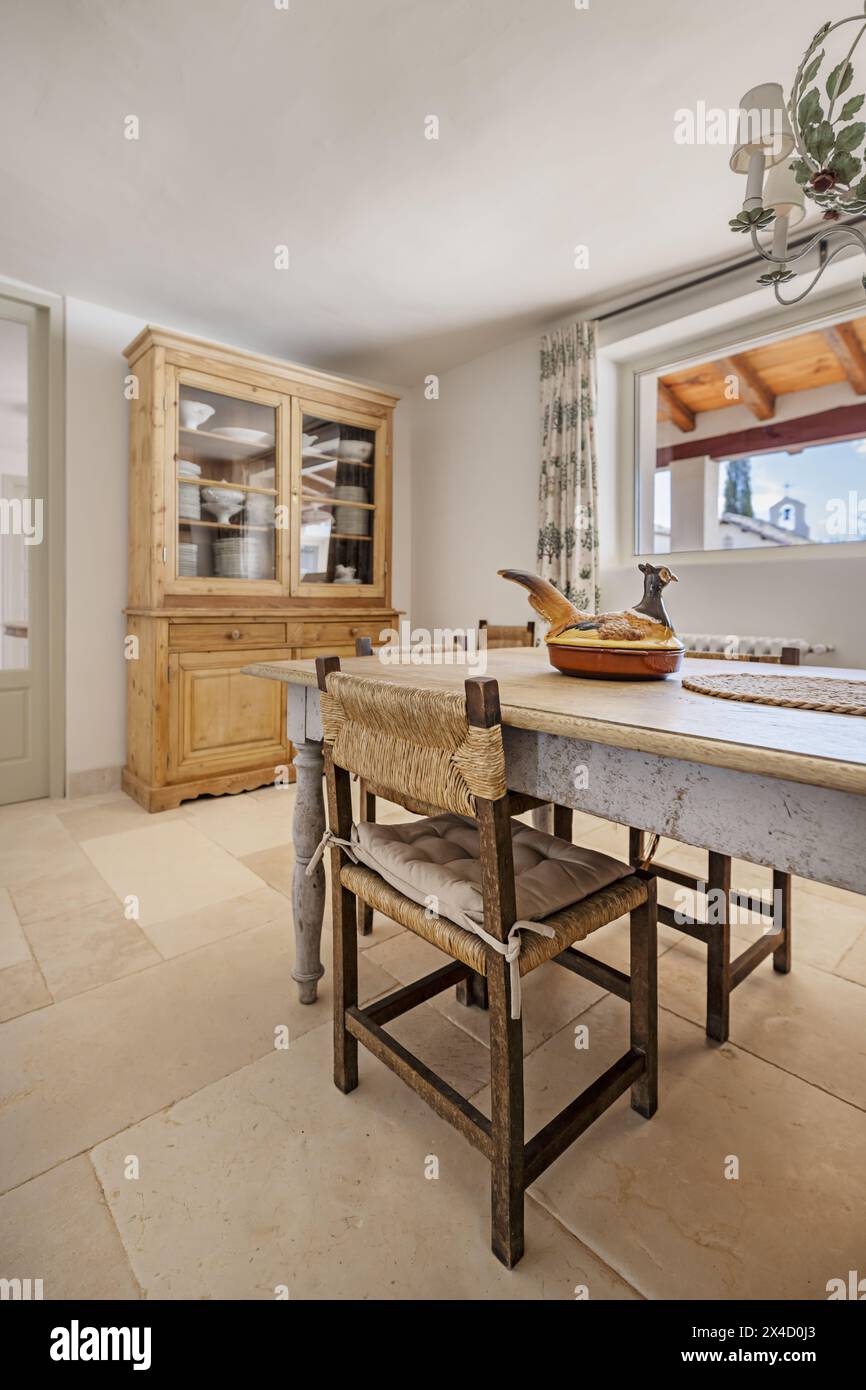 Corner detail of a rustic style wooden dining table with matching ...