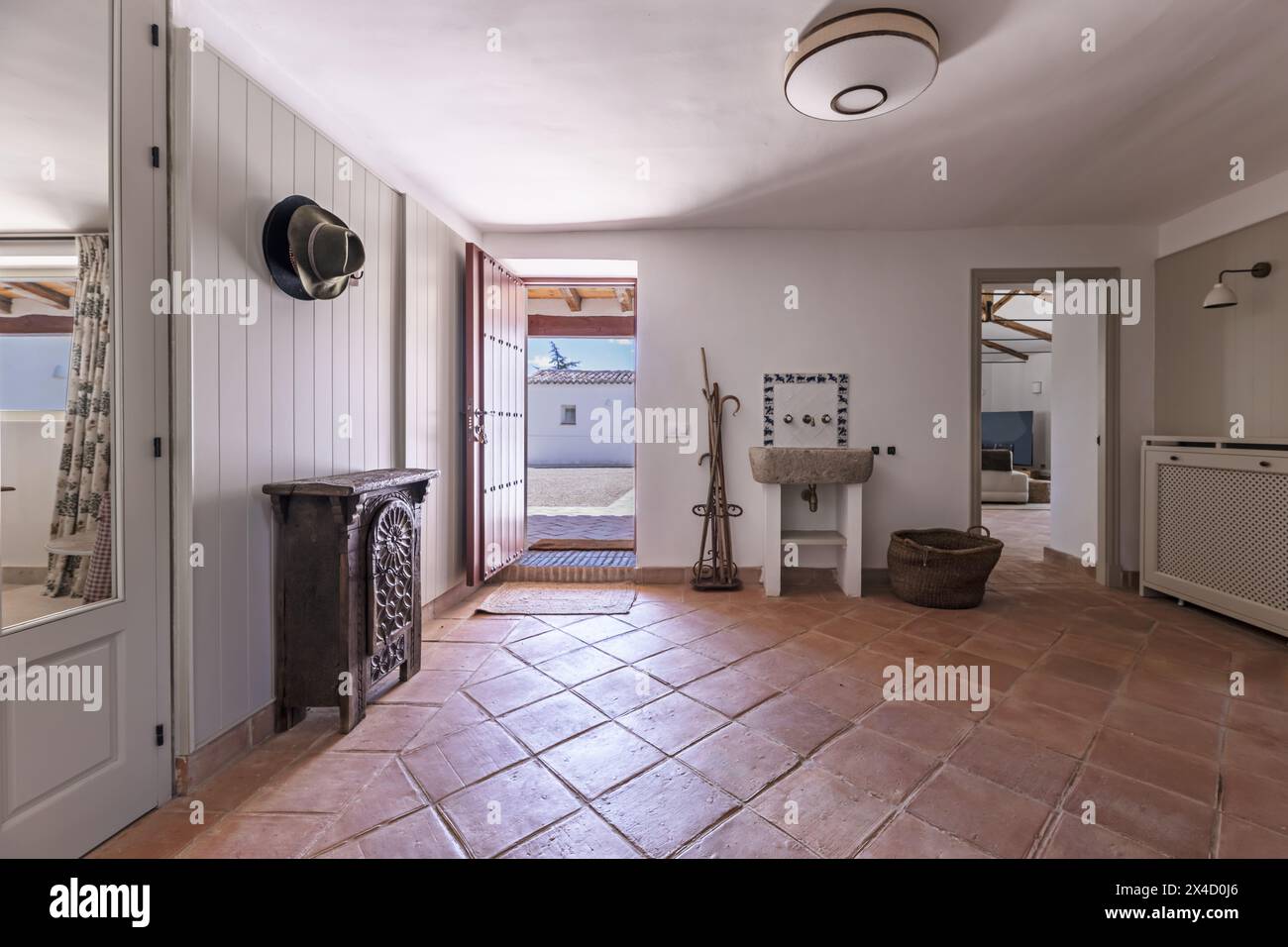Hallway of a country house with vintage-style terracotta floors and ...