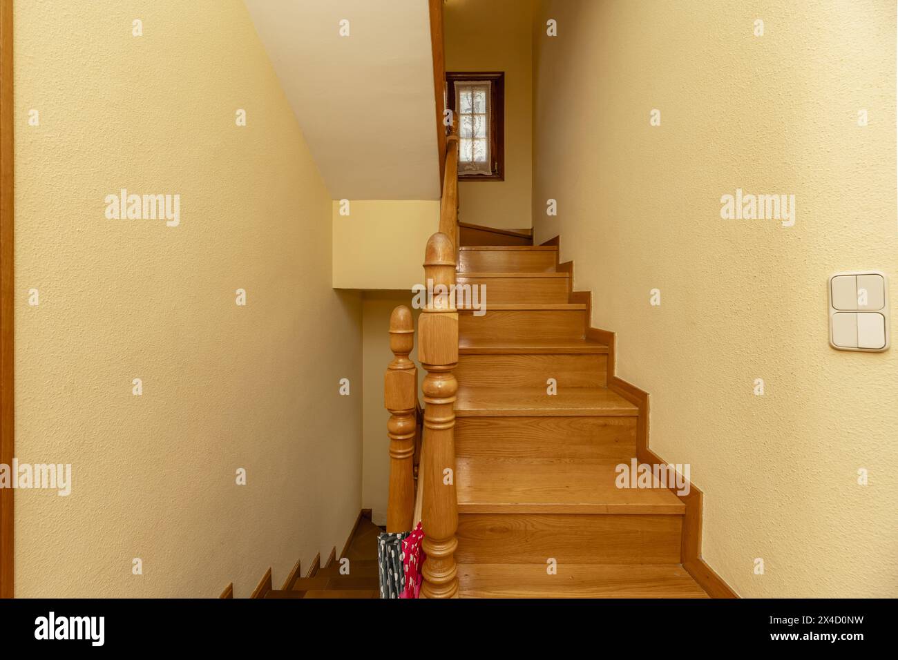Interior stairs of a single-family home with oak wood balustrades with ...