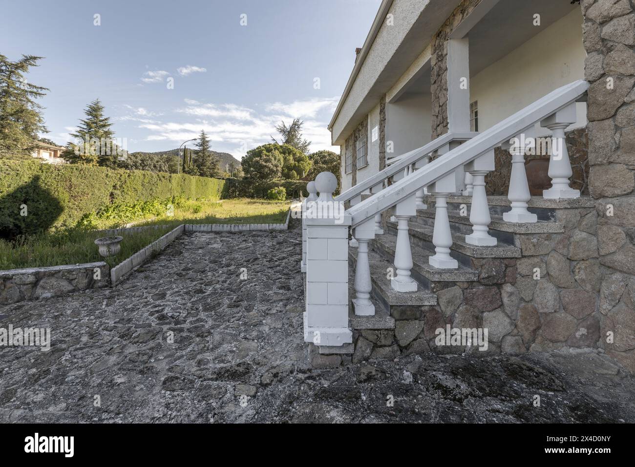 Stairs and exterior railings of a single-family home with white ...