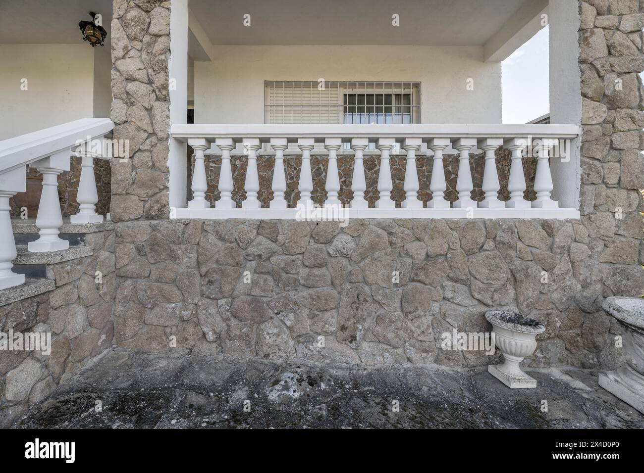 Stairs and exterior railings of a single-family home with white ...