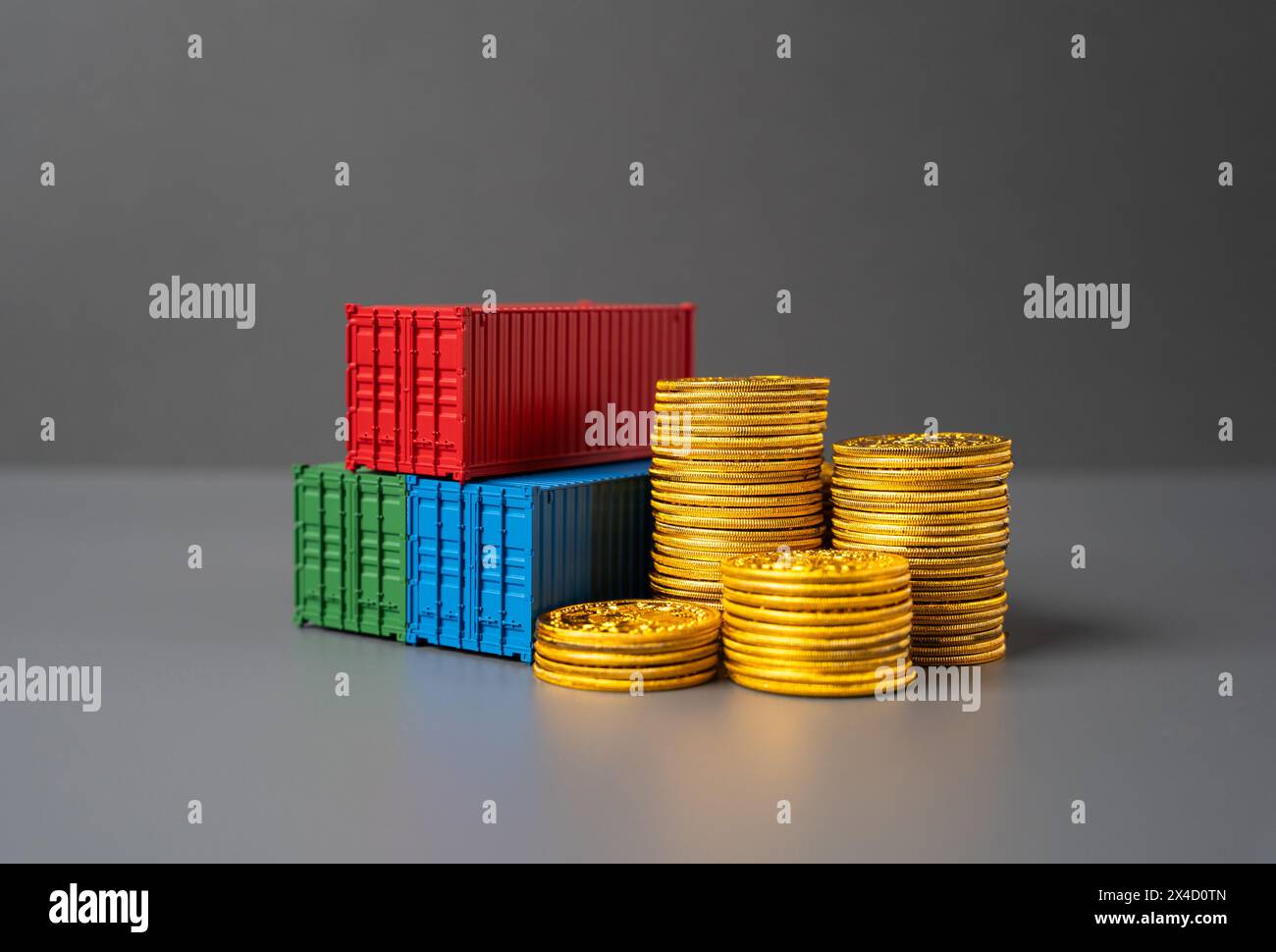 Sea trade containers and a stack of coins. World trade. Prices, tariffs ...