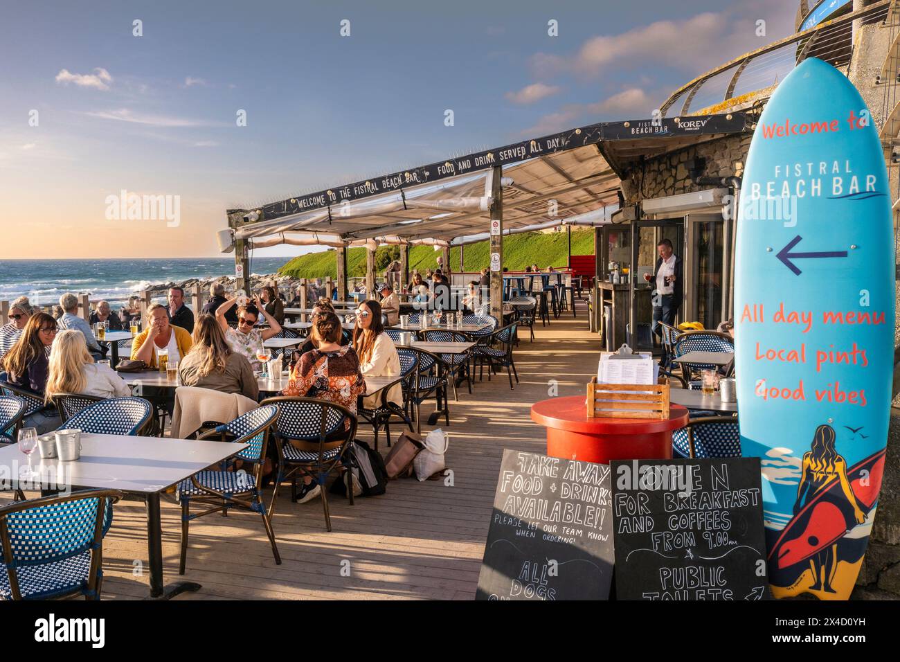 People enjoying the evening sitting on the outdoor seating area of ...