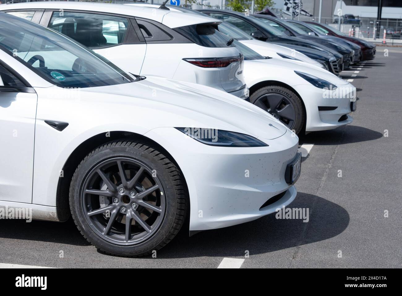 Many Tesla electric cars refueling on street parking lot, Automotive ...