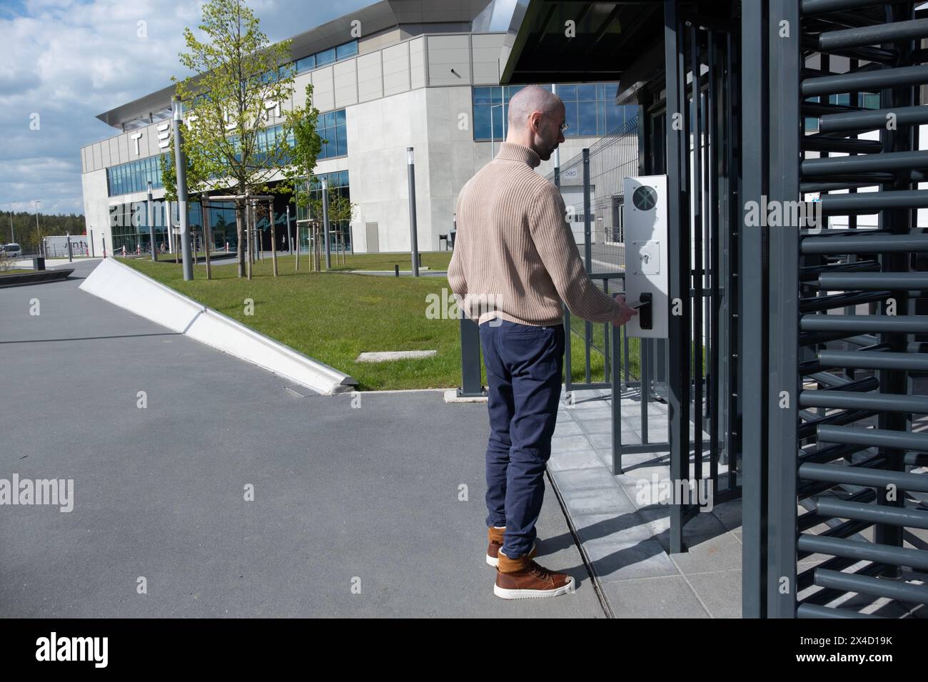 man passes through checkpoint manufacturing plant, phone to scan code ...