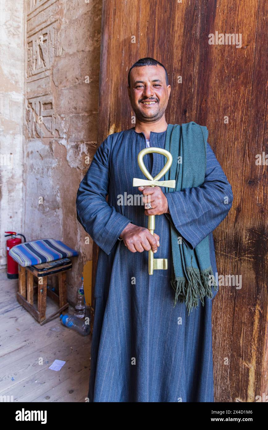 Abu Simbel, Aswan, Egypt. Caretaker holding a large key in the shape of ...