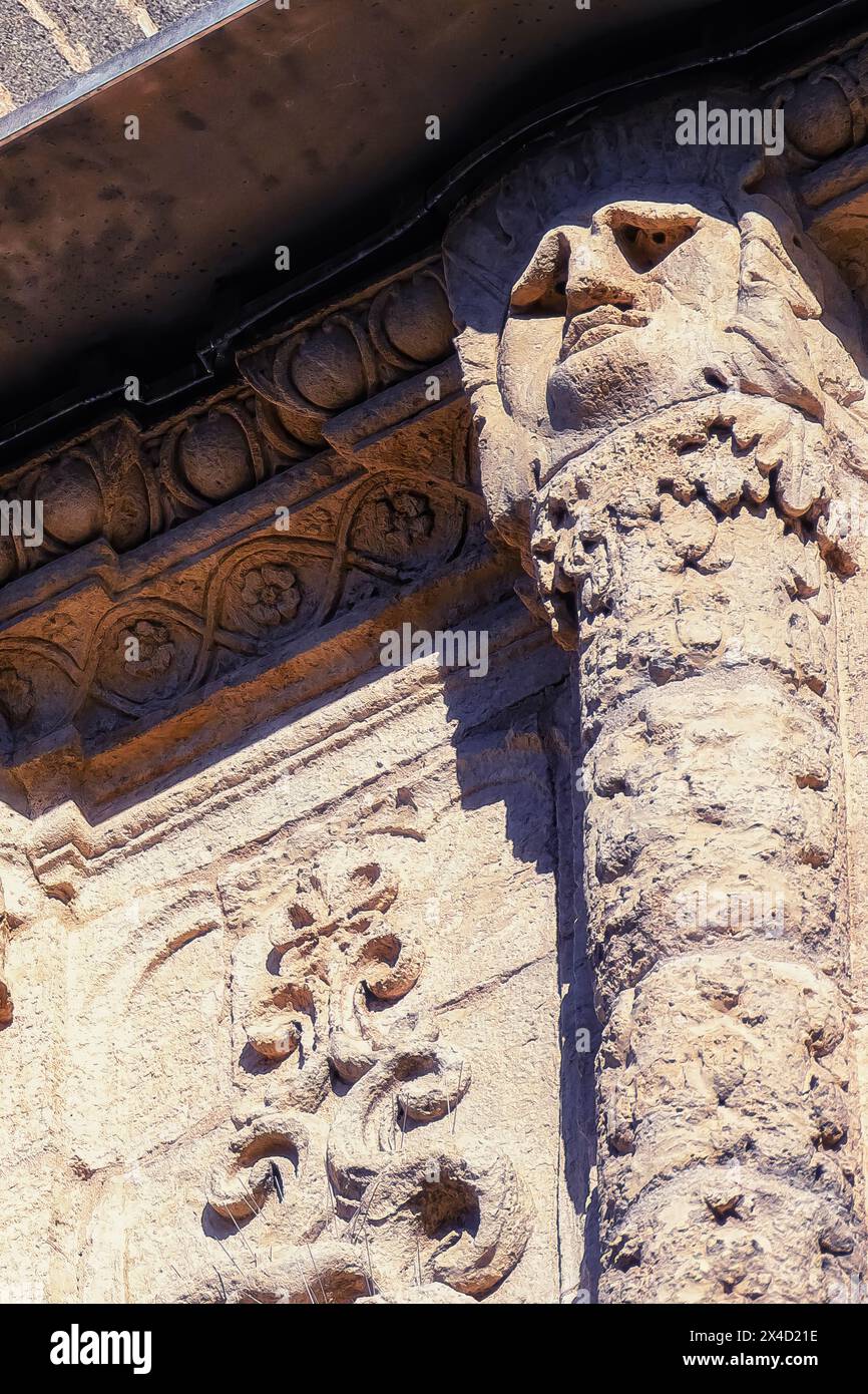 Column capital gargoyle on the medieval facade of the Avila Cathedral ...