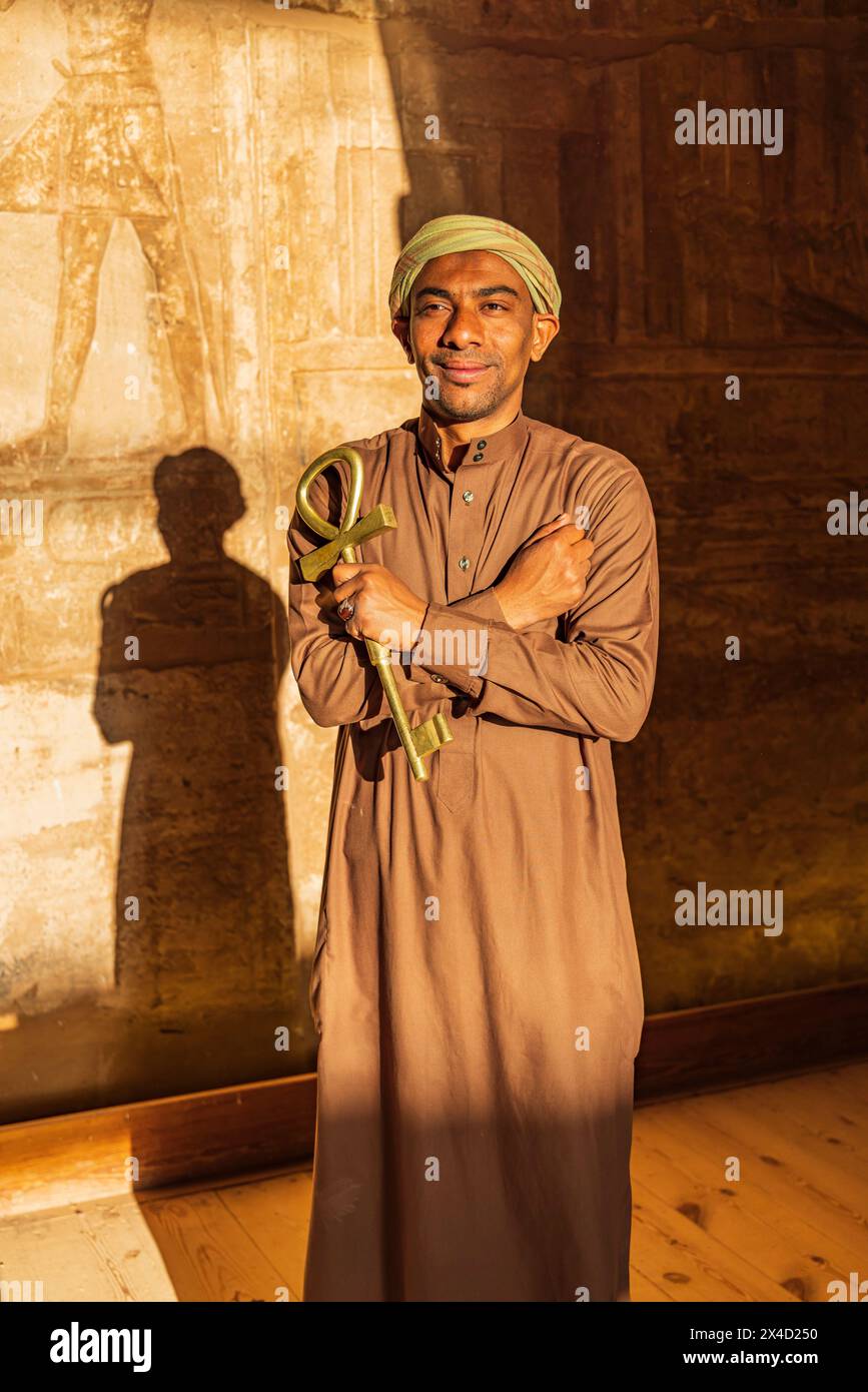 Abu Simbel, Aswan, Egypt. Caretaker holding a large key in the shape of ...
