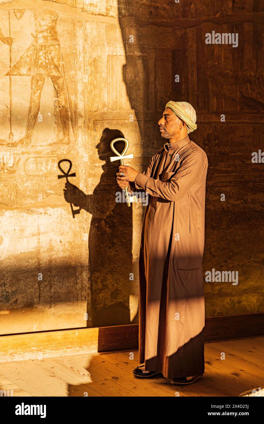 Abu Simbel, Aswan, Egypt. Caretaker holding a large key in the shape of ...