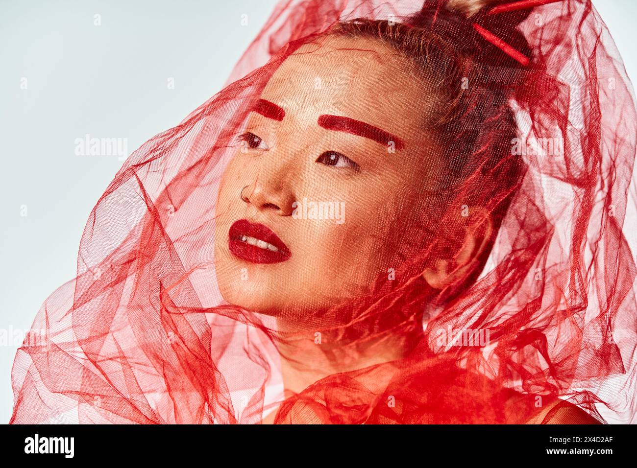 A young beauty wearing a red veil hi-res stock photography and images ...