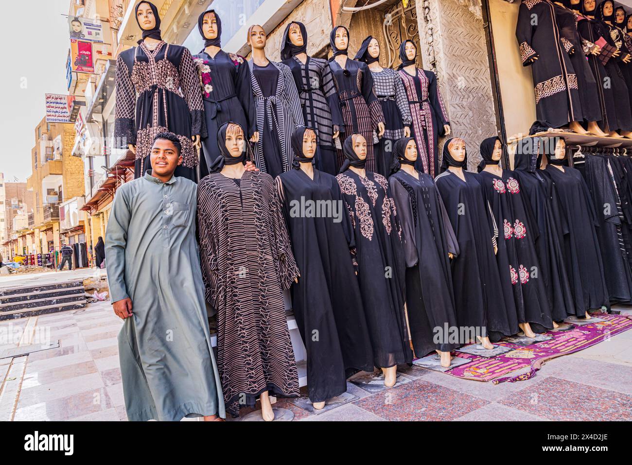 Thebes, Luxor, Egypt. Traditional abayas for sale at a clothing store ...