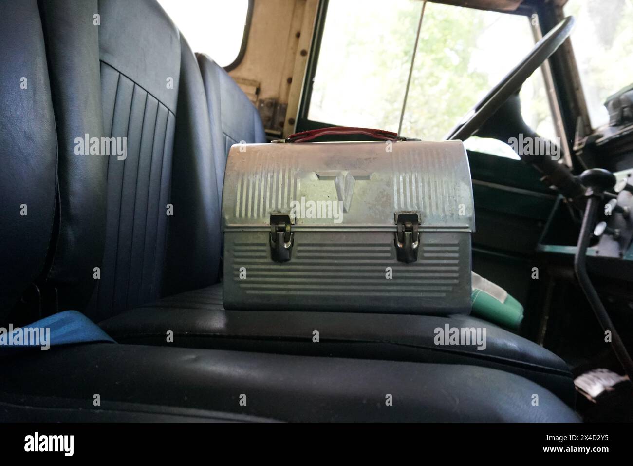 A lunch box on the seat of a 1967 Landrover. photo by Dennis Brack ...