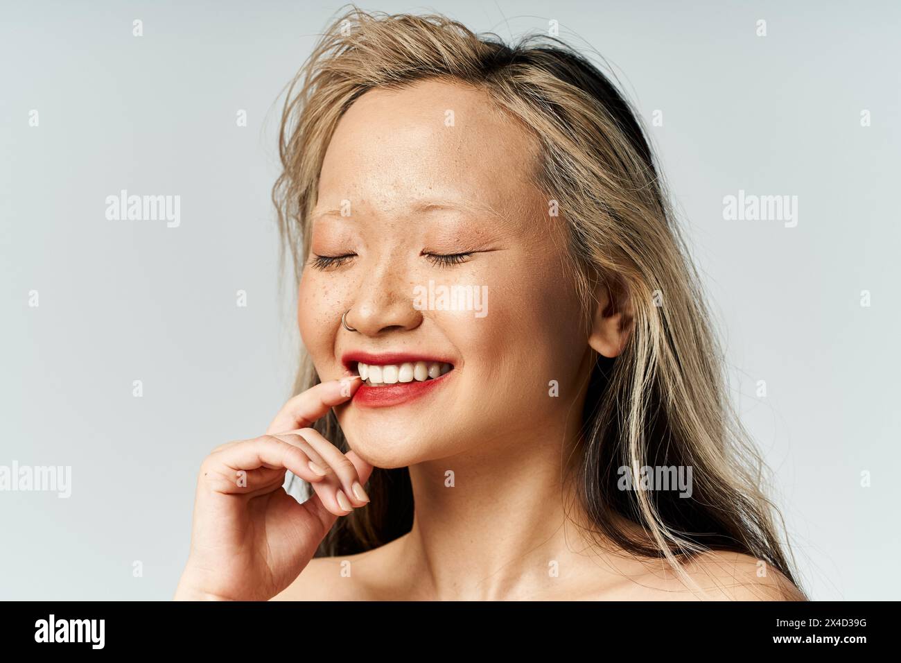 An attractive Asian woman in colorful attire smiling radiantly Stock ...